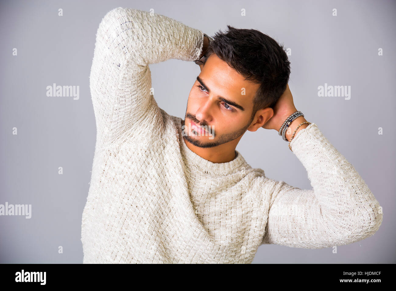 Handsome young man wearing white sweater Stock Photo - Alamy