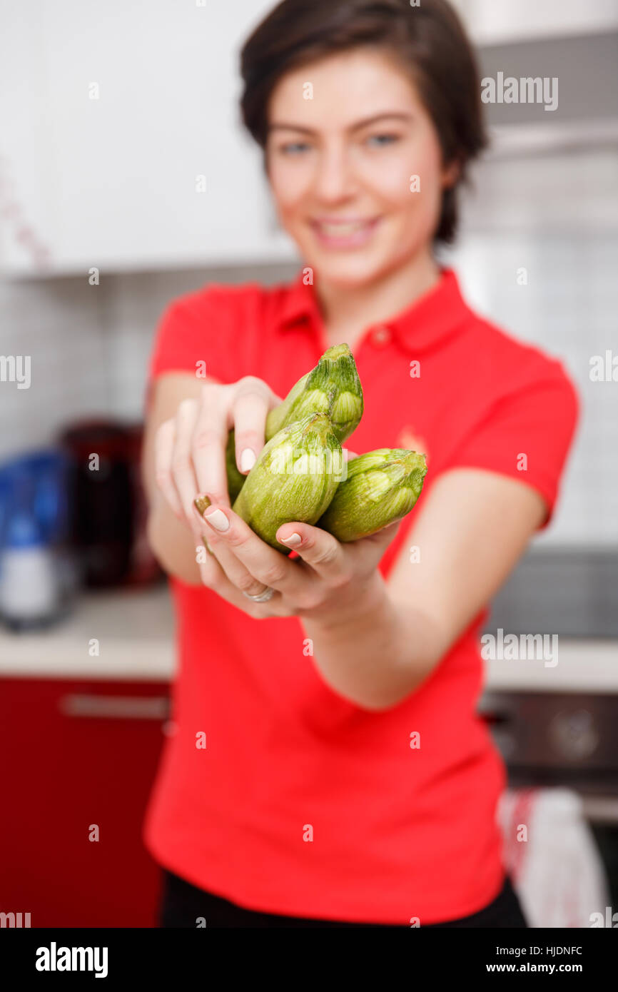 Woman with zucchini in kitchen Stock Photo - Alamy