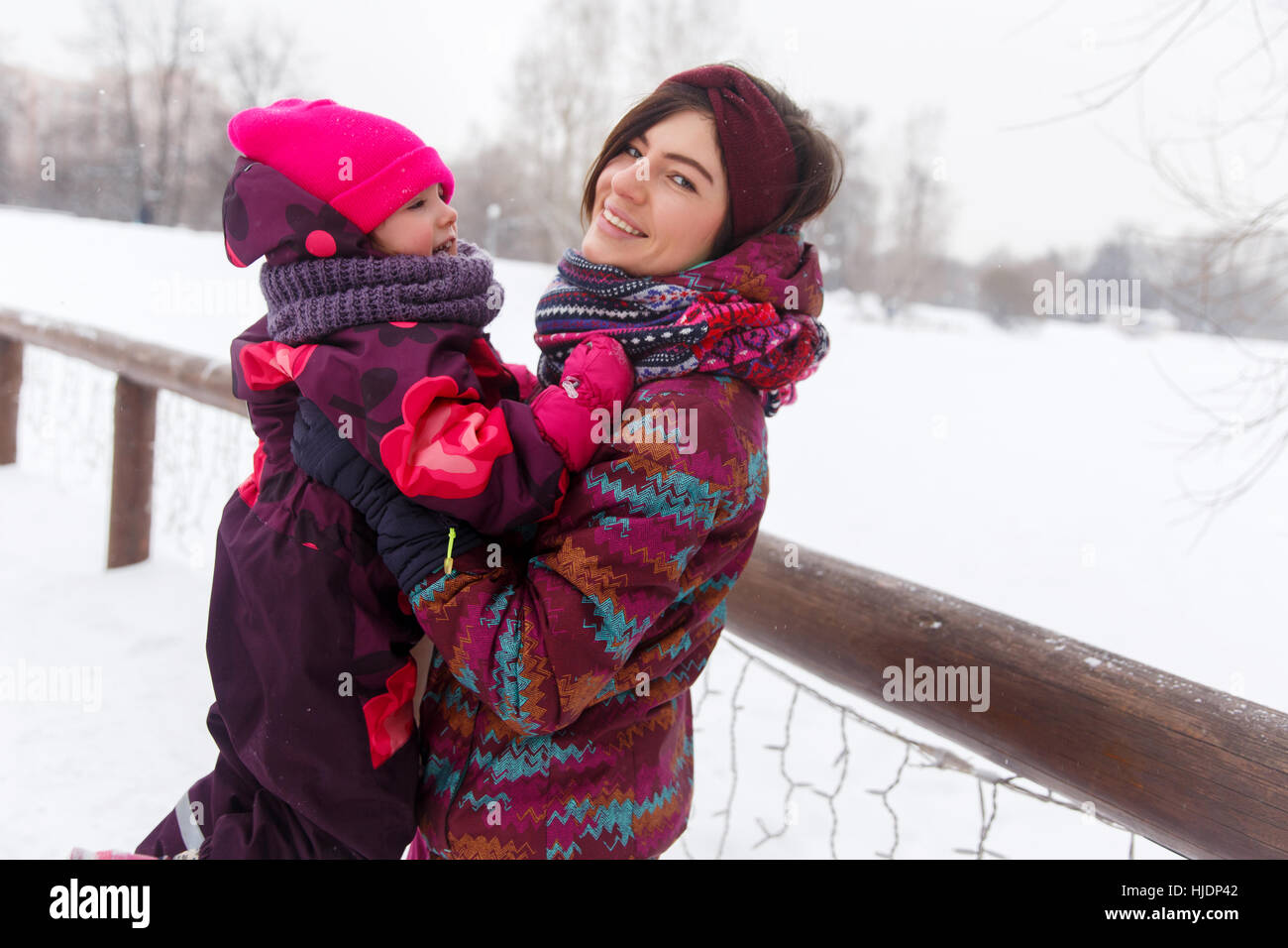 Woman with child in winter Stock Photo - Alamy
