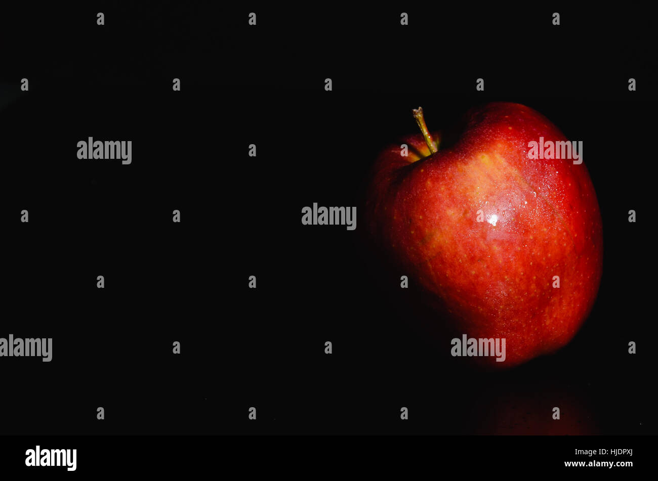 Red Apple On Black Background Stock Photo - Alamy