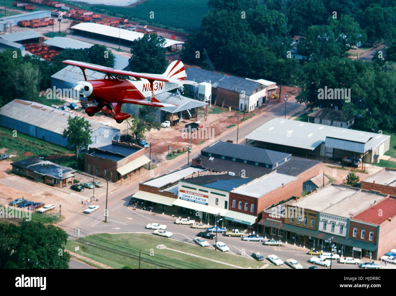 A Pitts Special biplane flies over the Main Street of Plains, Georgia ...
