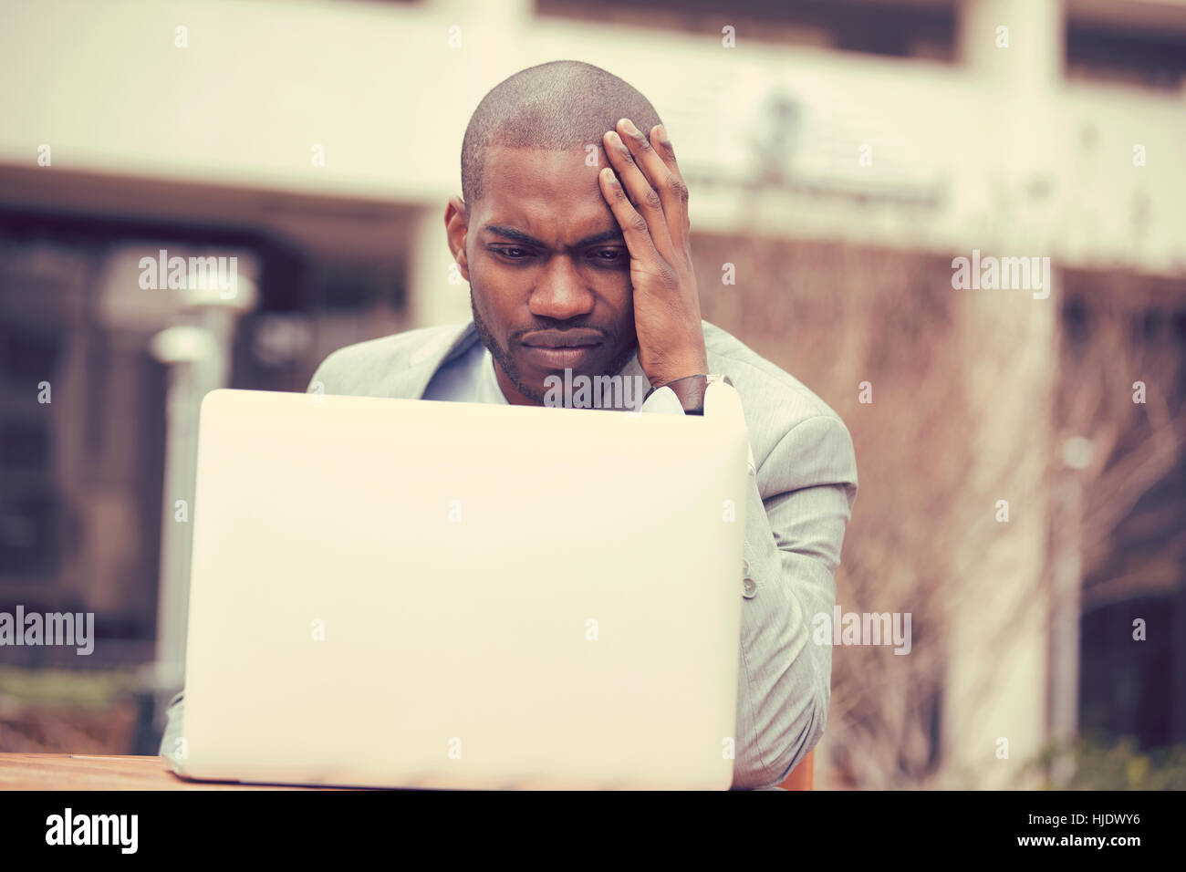 African businessman migraine sitting outdoor hi-res stock photography ...