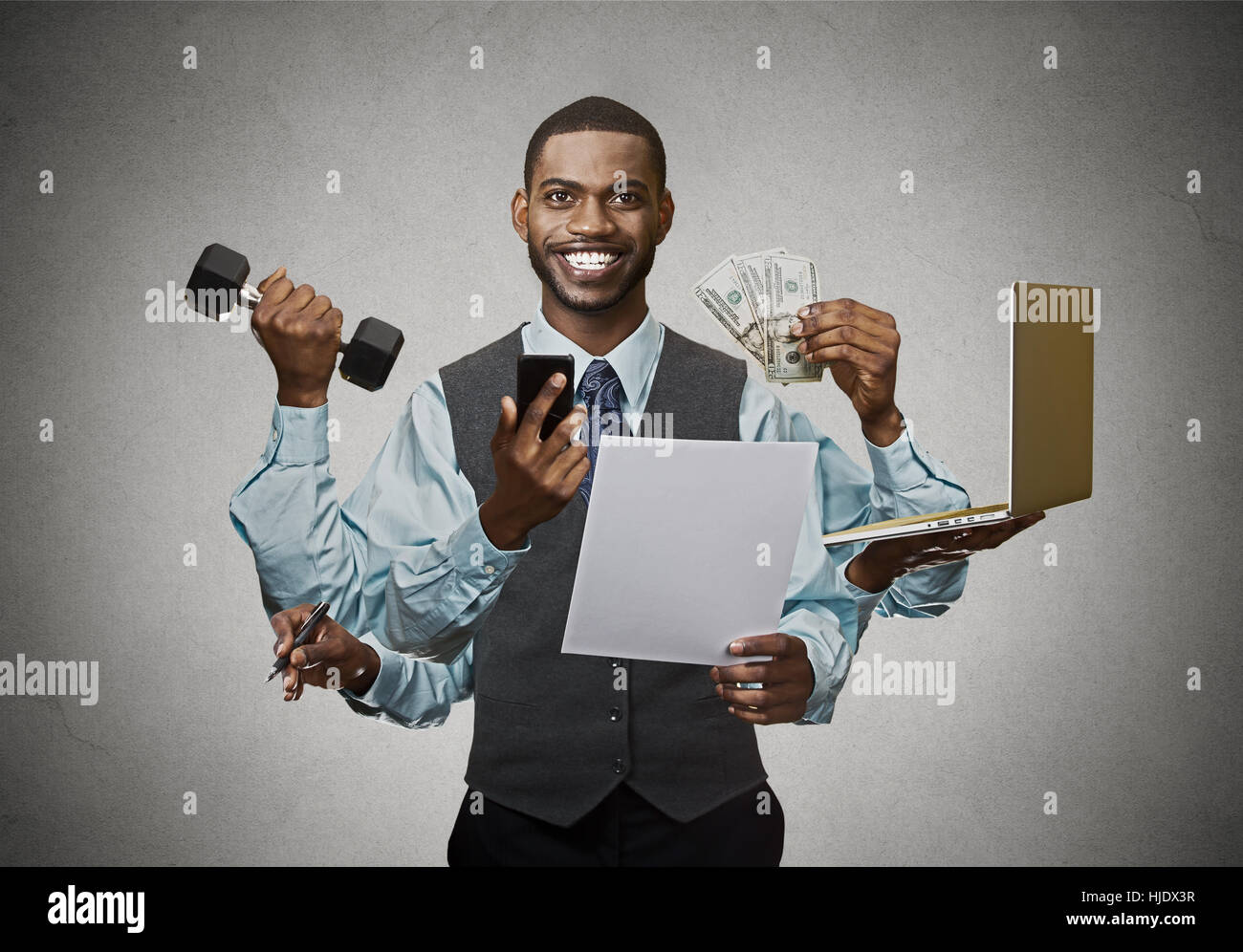Multitasking happy business man isolated on grey wall background. Busy ...