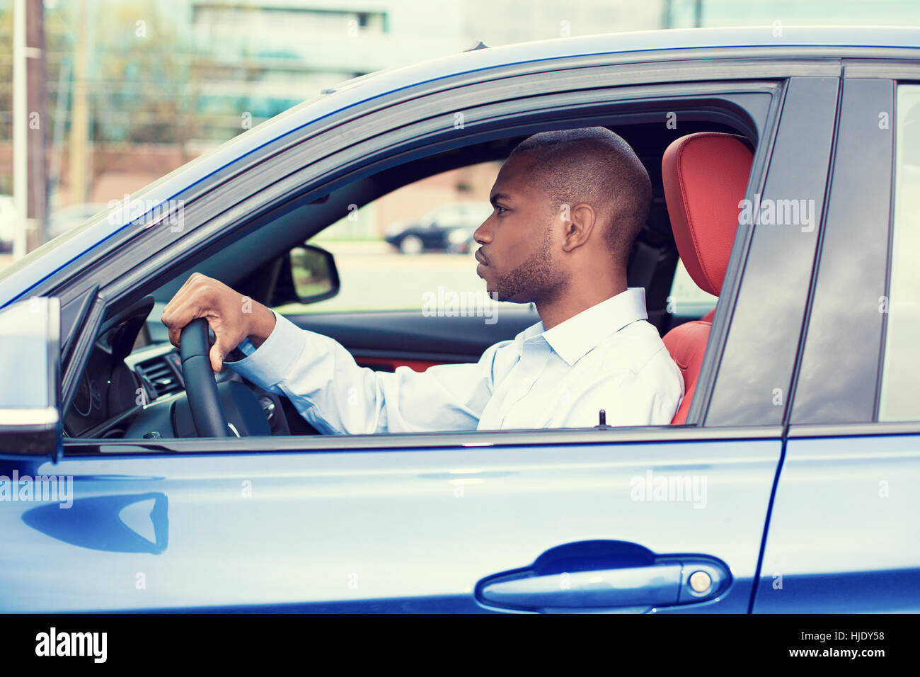 Closeup portrait young man driving his new car. Personal transportation ...