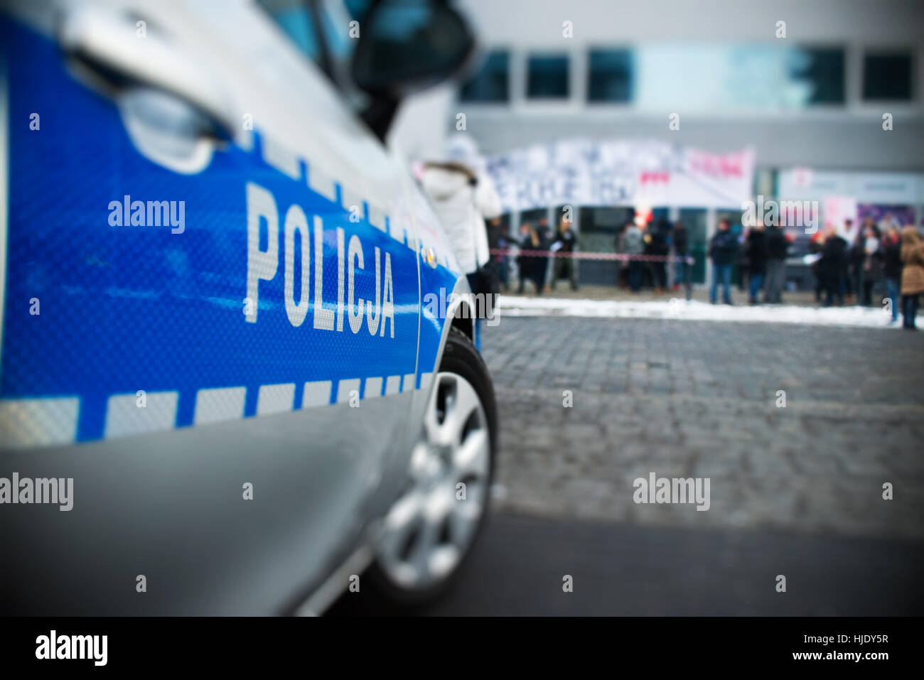 detail of a police (Policja) car in Poland, demonstration in background ...