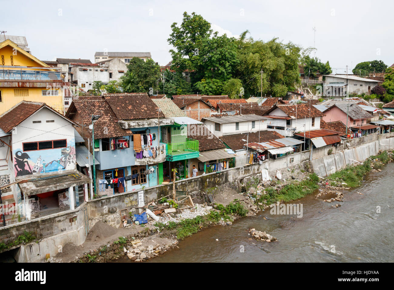 View over slums on the banks of Kali Code, a small river flowing ...