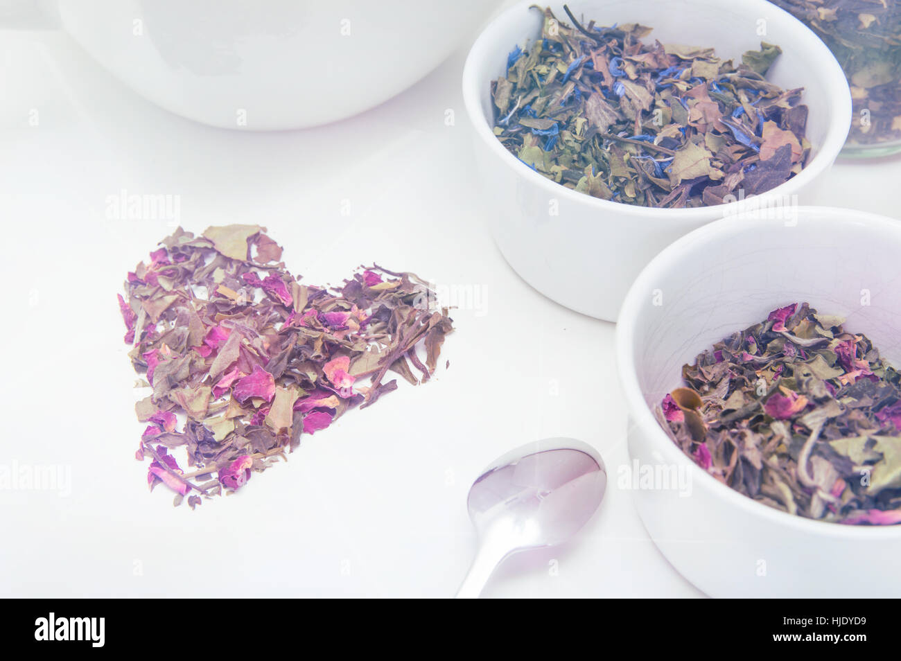 Heart arranged with green tea leaves and different kind of herbs on ...