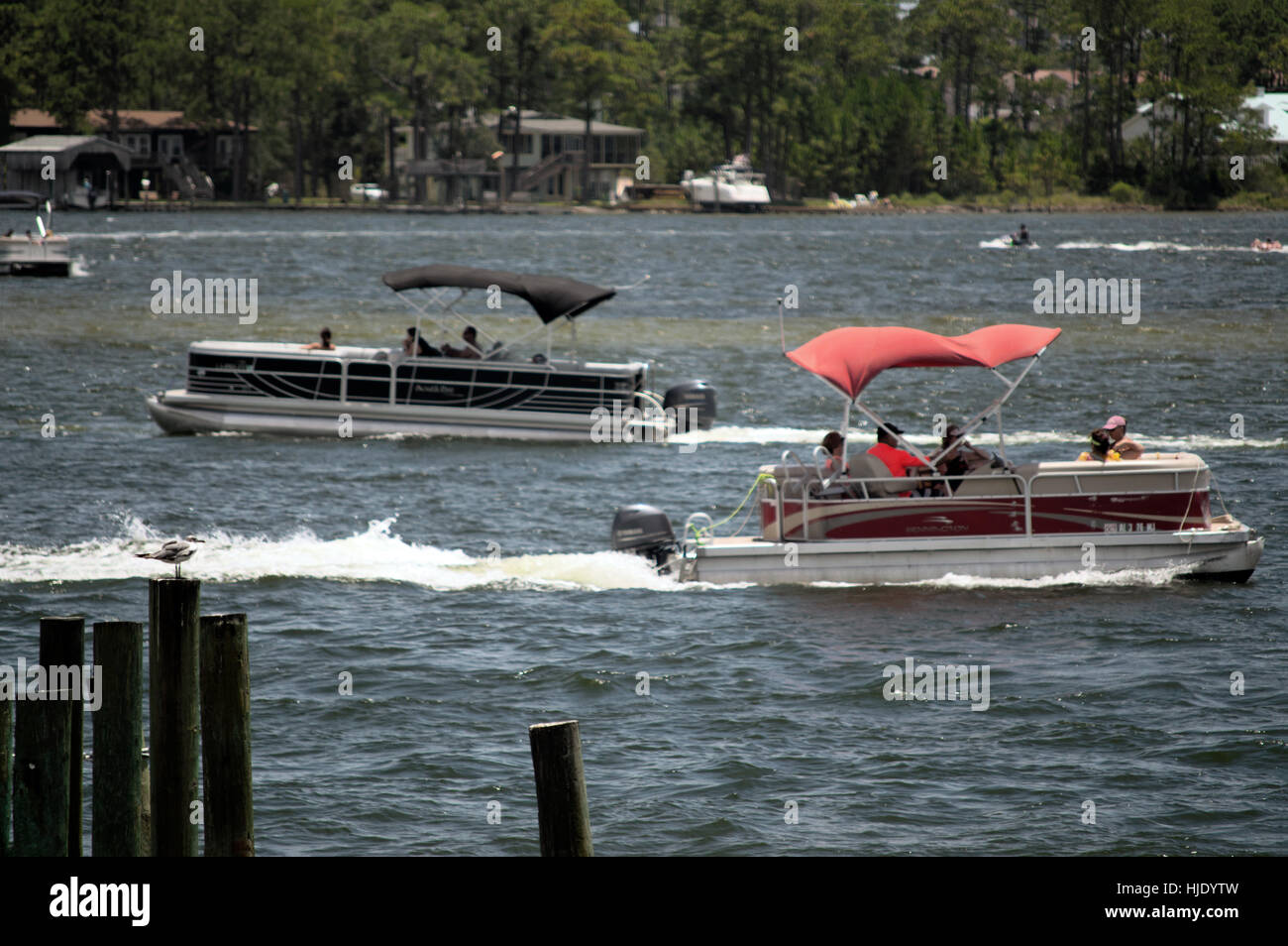 Two pontoon boats sailing by side by side Stock Photo - Alamy