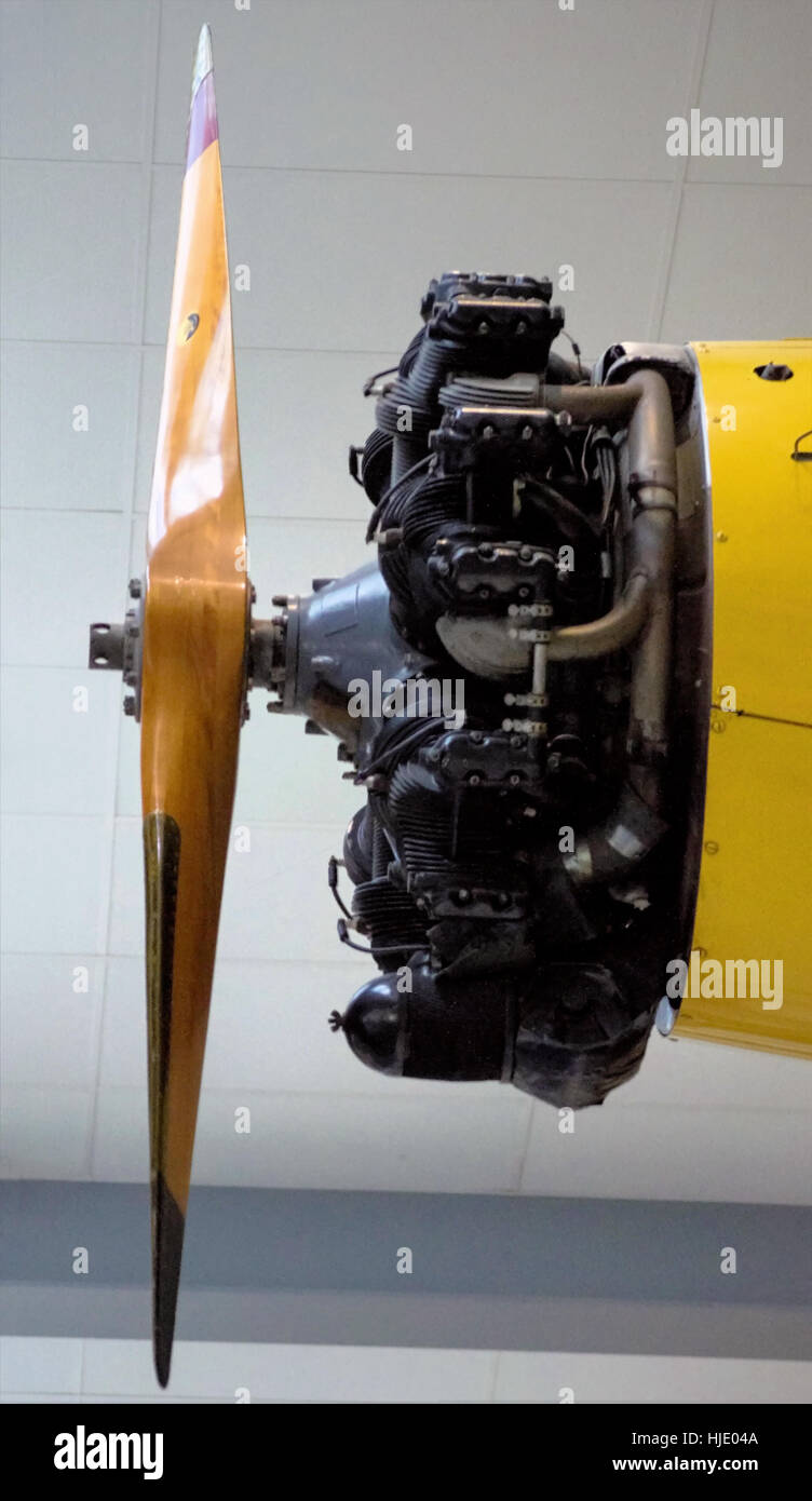 An engine for a yellow biplane with wooden propellers at a museum ...