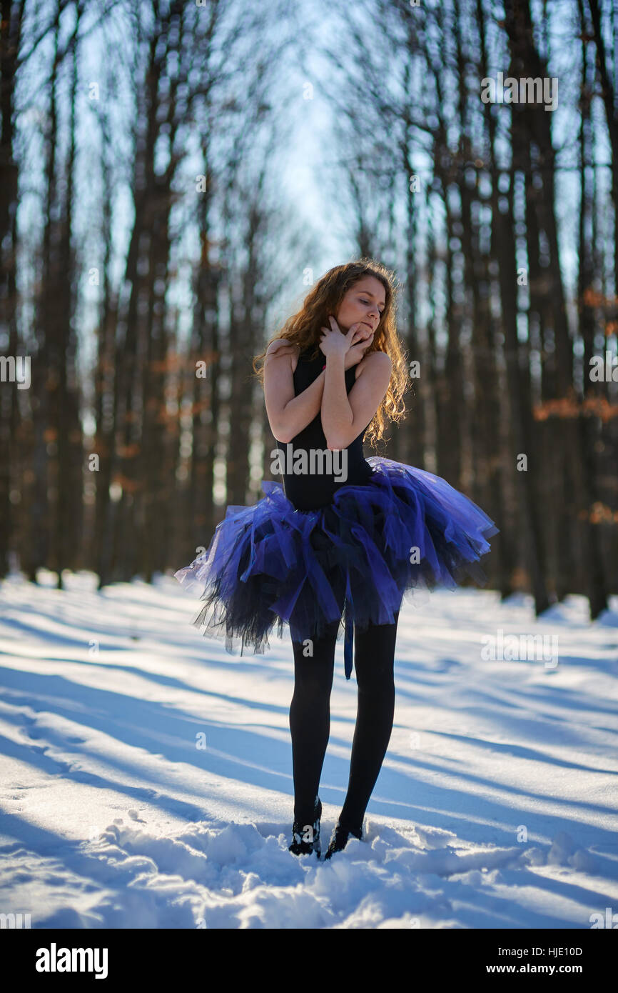 Ballerina dancing outdoor in the snow, in a forest Stock Photo - Alamy