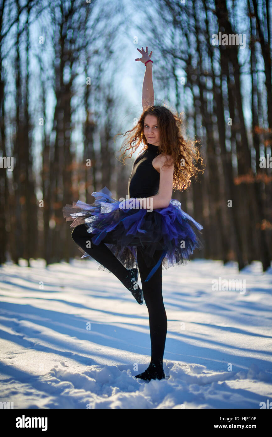 Ballerina dancing outdoor in the snow, in a forest Stock Photo - Alamy