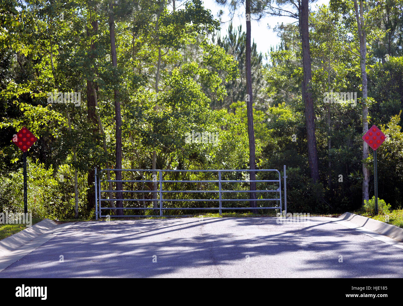 Two red signs and a gate blocking entrance to a forest Stock Photo - Alamy