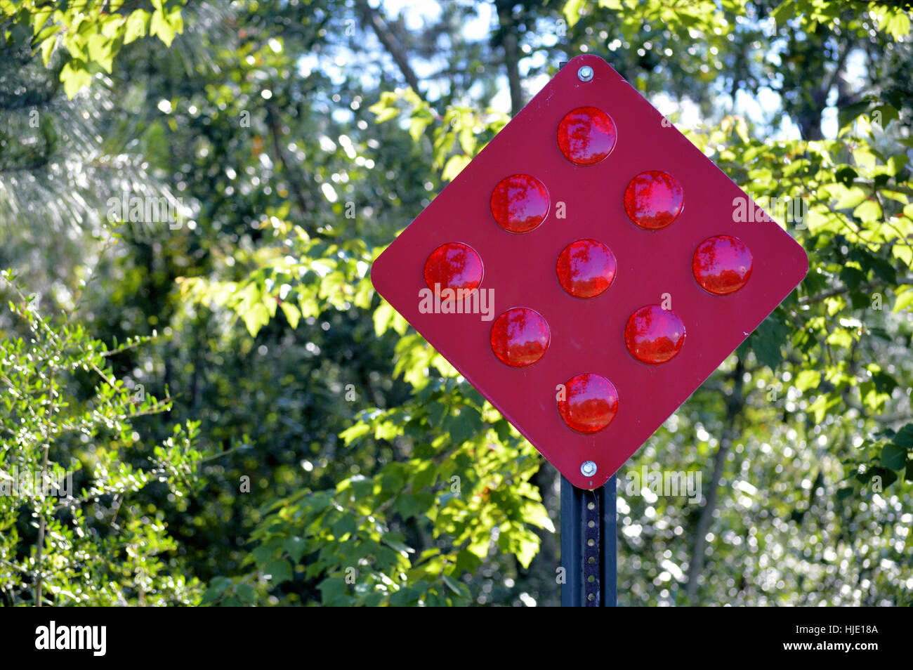 A red caution sign post against a background of a forest Stock Photo ...
