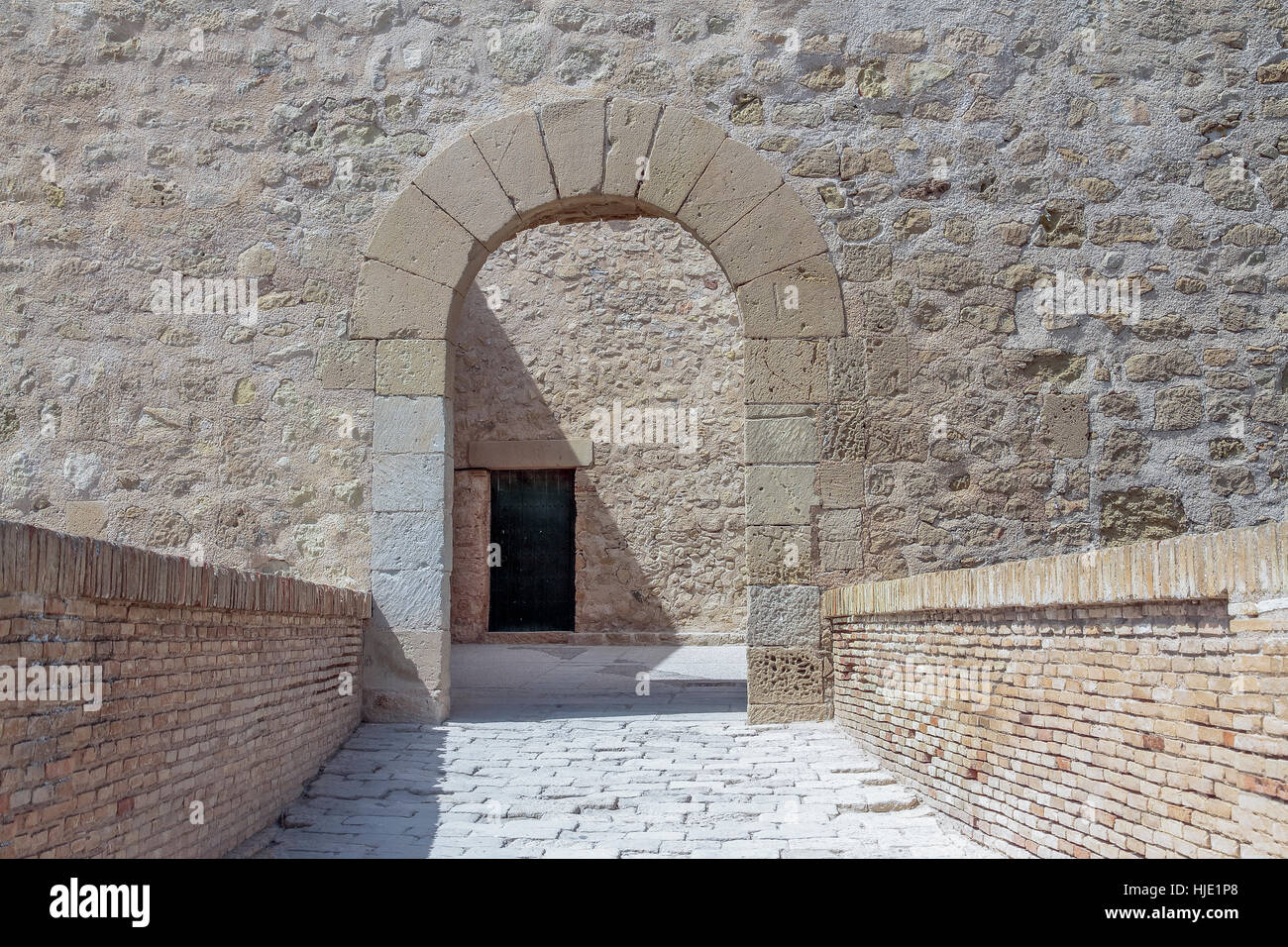 horizontal view of access arch of stone and an ancient door in the ...