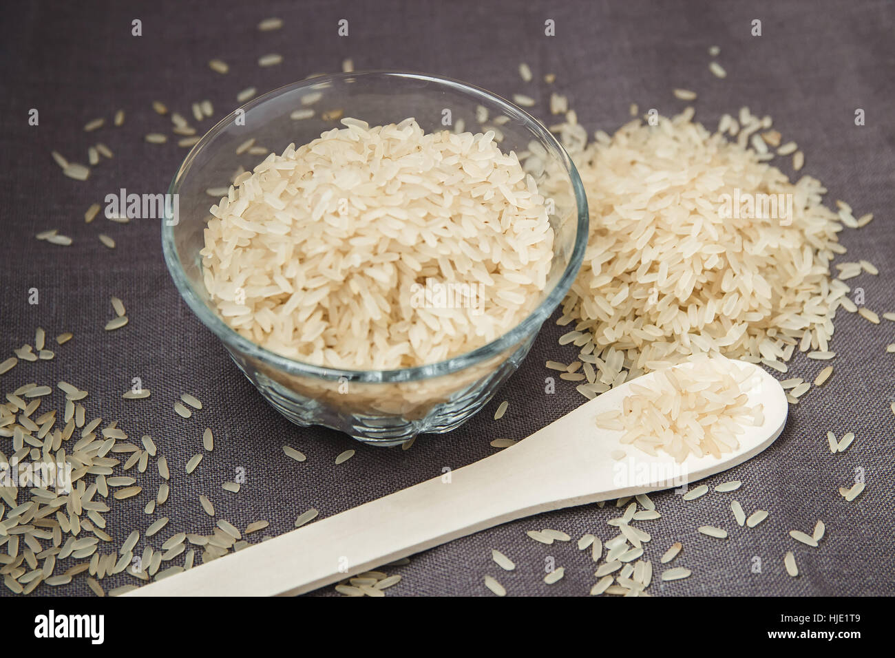 Plate and wooden spoon with white rice Stock Photo - Alamy