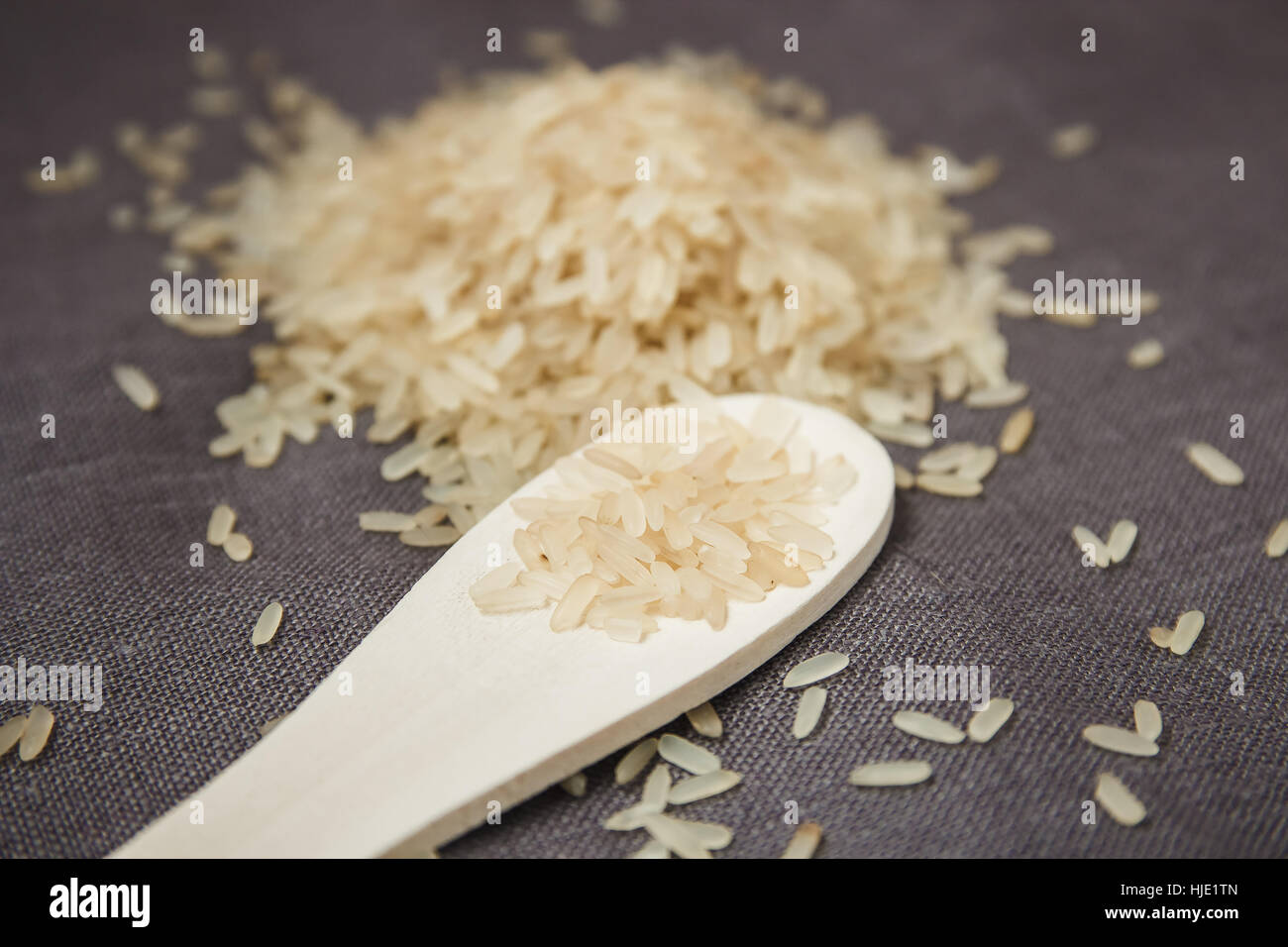 wooden spoon with white rice Stock Photo - Alamy