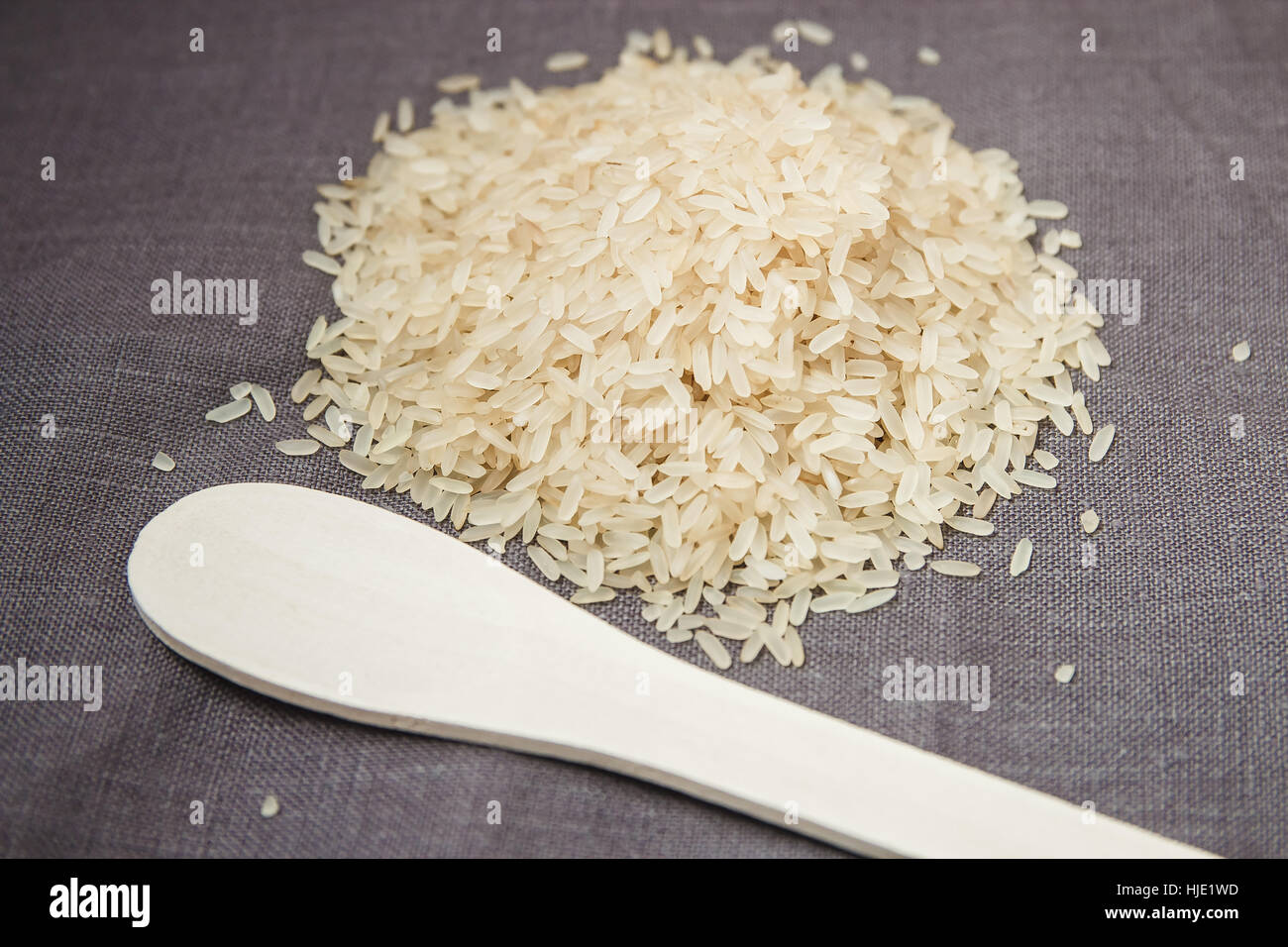 wooden spoon with white rice Stock Photo - Alamy