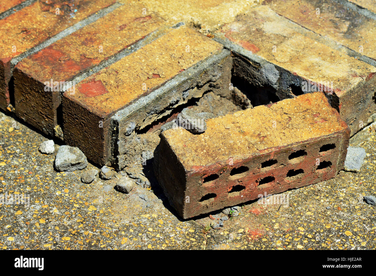 A brick broken off a row of bricks with mortar laying beside it Stock ...