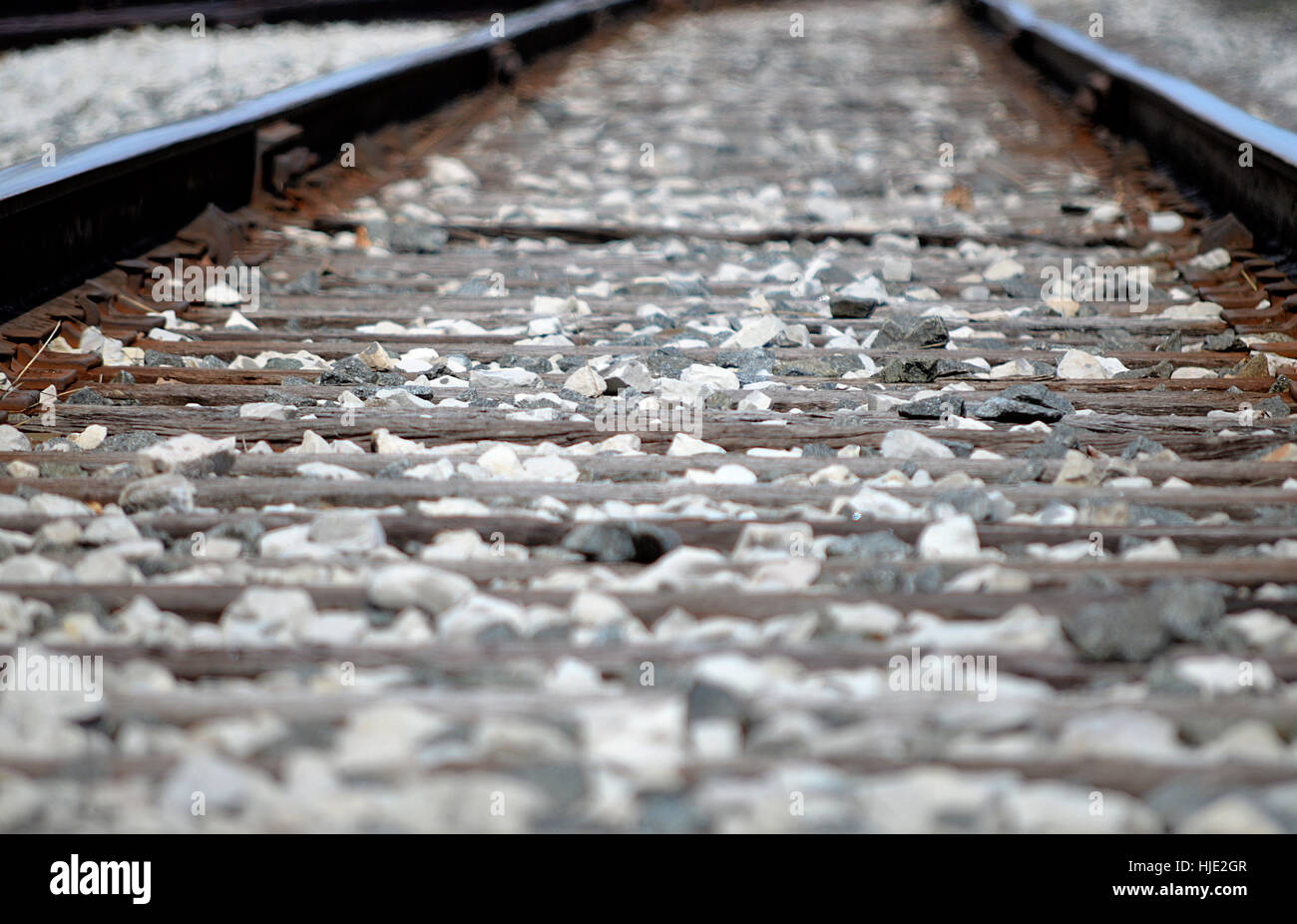 Looking down a railroad track with gravel and railroad ties. Concept ...