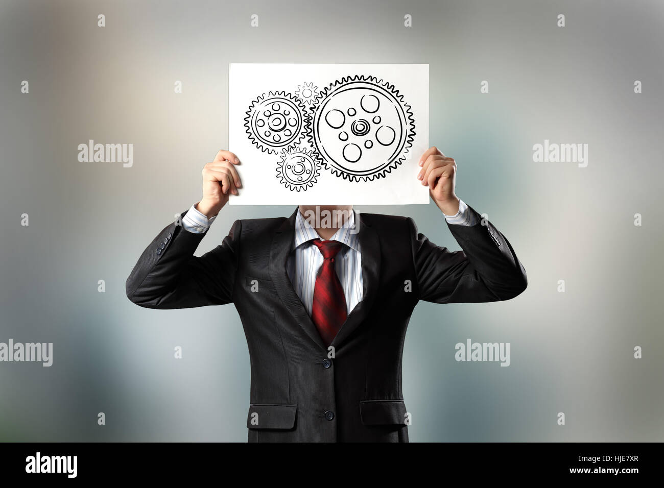 Businessman hiding face behind paper sheet. Working business mechanism ...