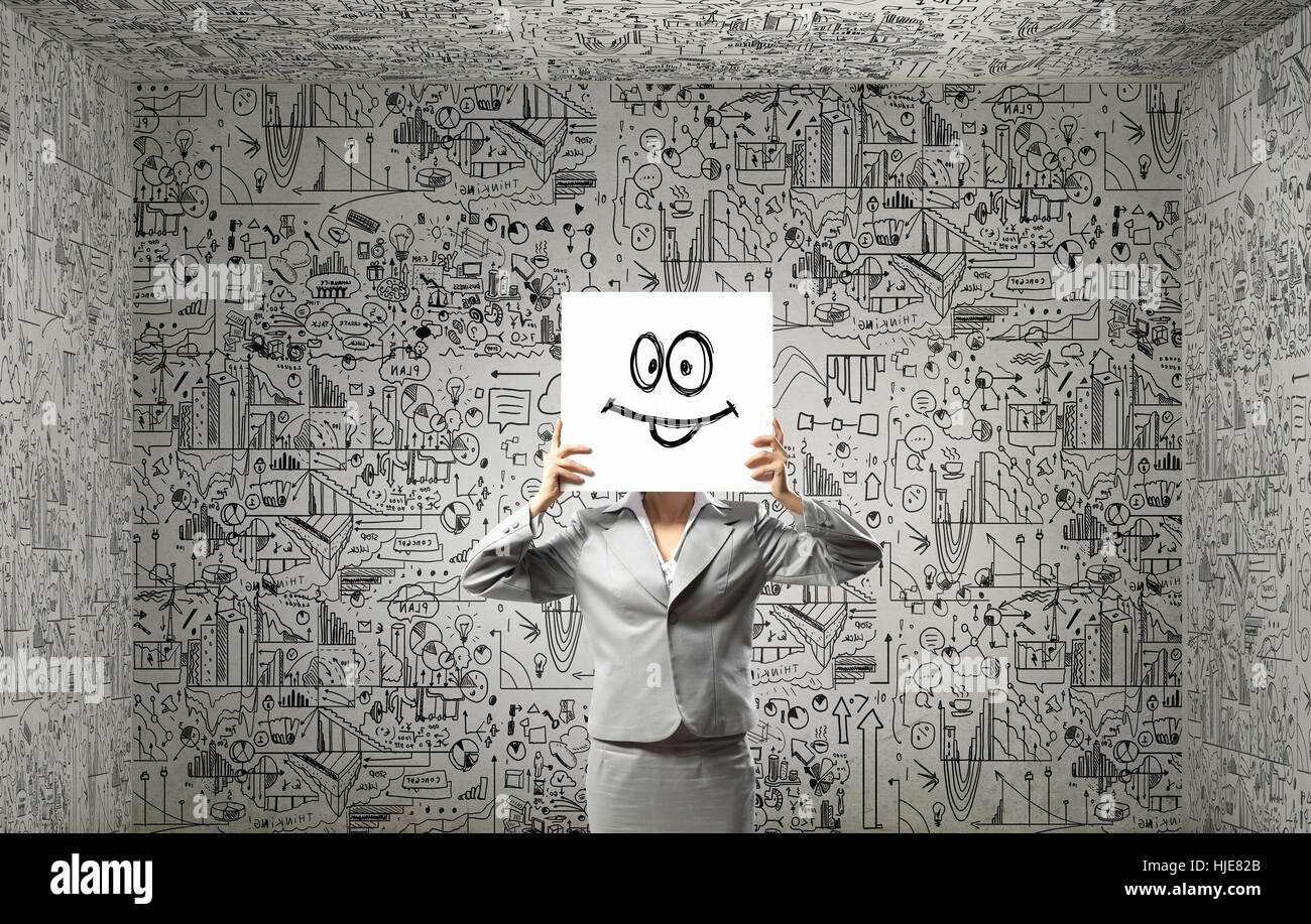 Businesswoman hiding her face behind paper list hi-res stock ...