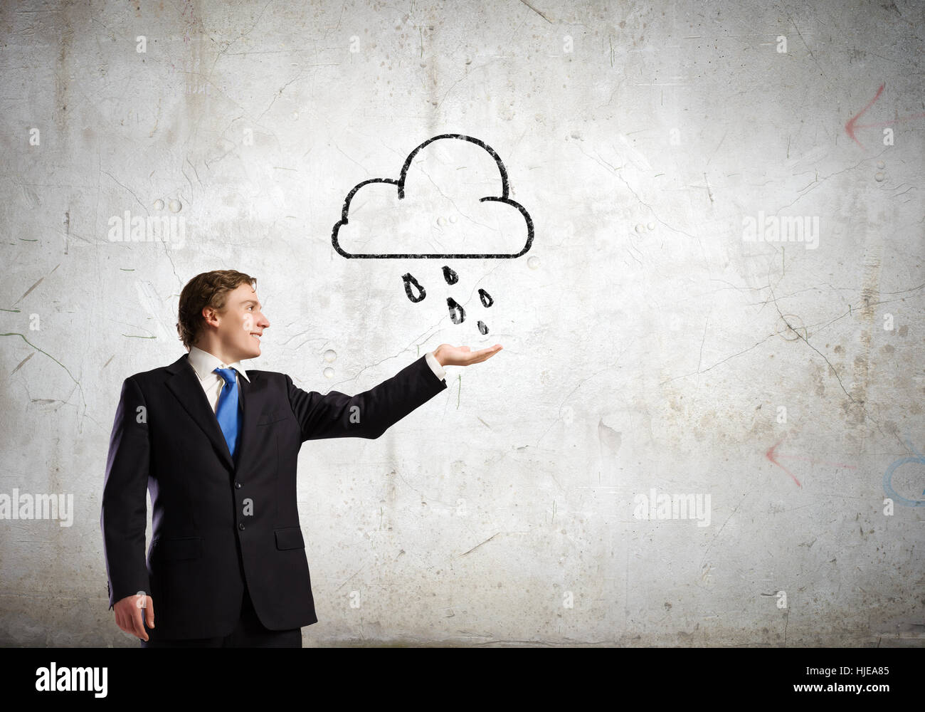 Young businessman holding palm to catch rain drops Stock Photo - Alamy