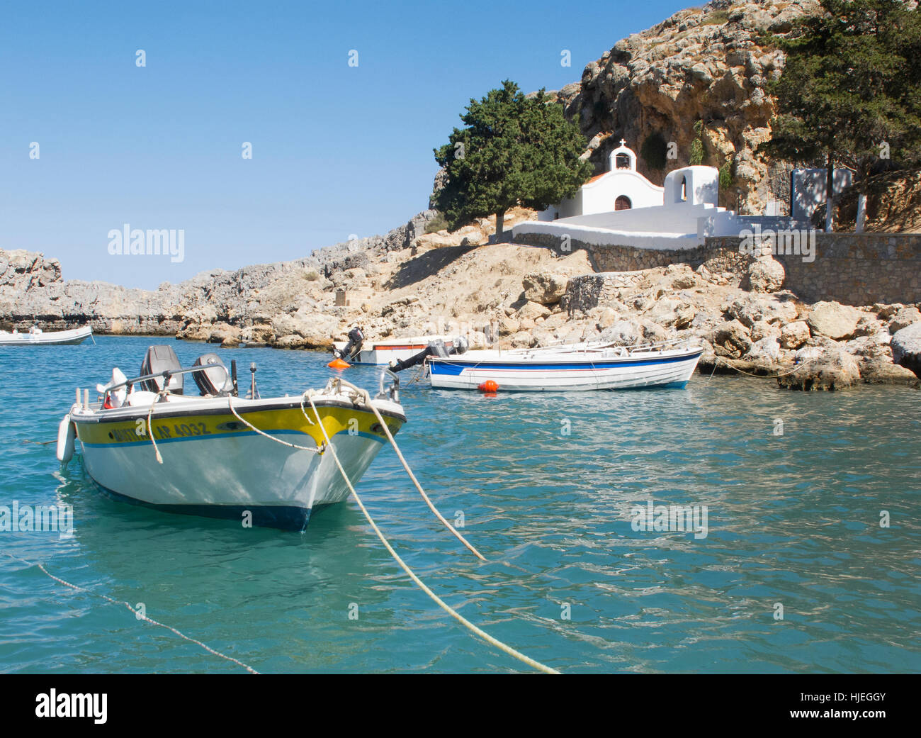 Boats and Church in bay at Lindos Rhodes Stock Photo - Alamy