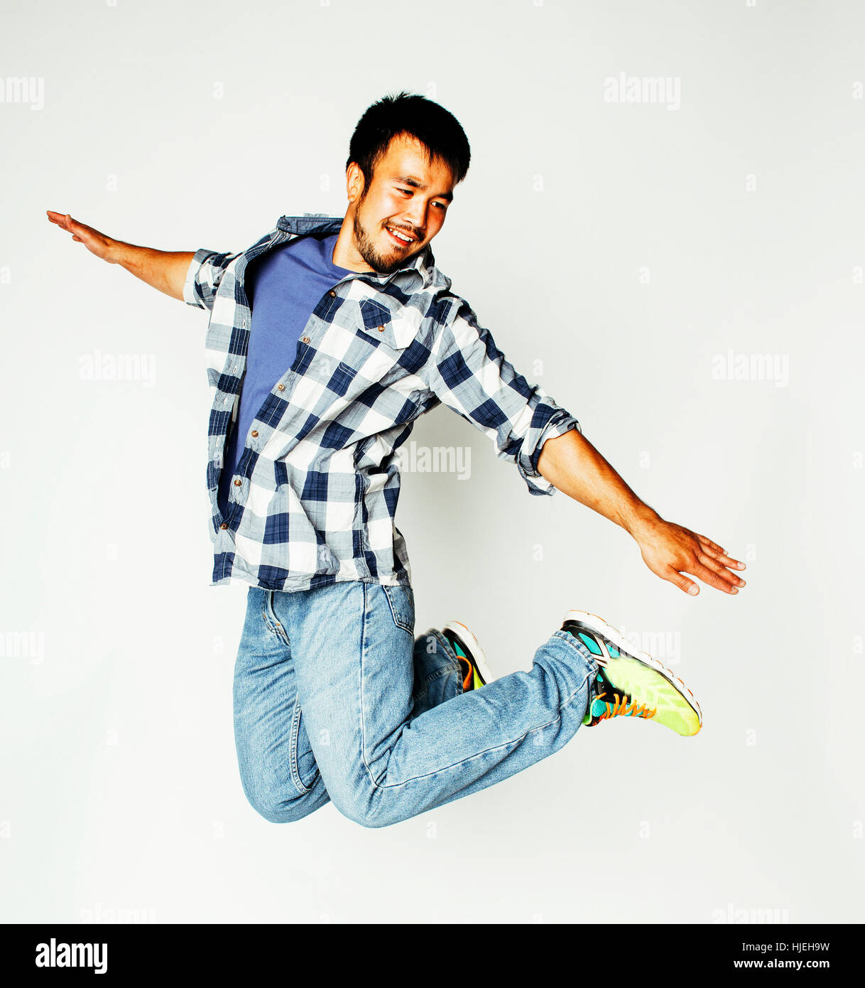young pretty asian man jumping cheerful against white background Stock ...