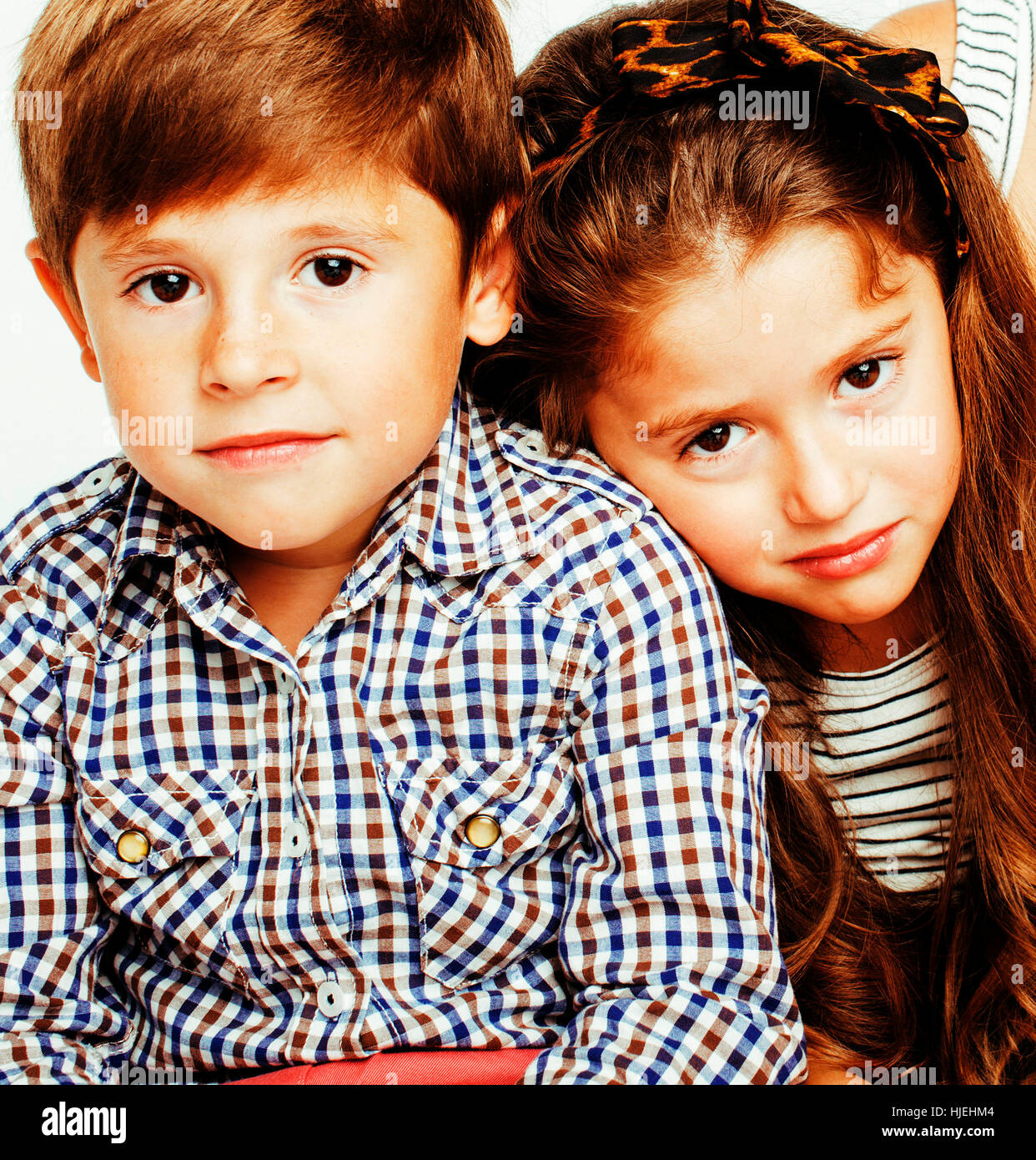 little cute boy and girl hugging playing on white background, ha Stock Photo - Alamy