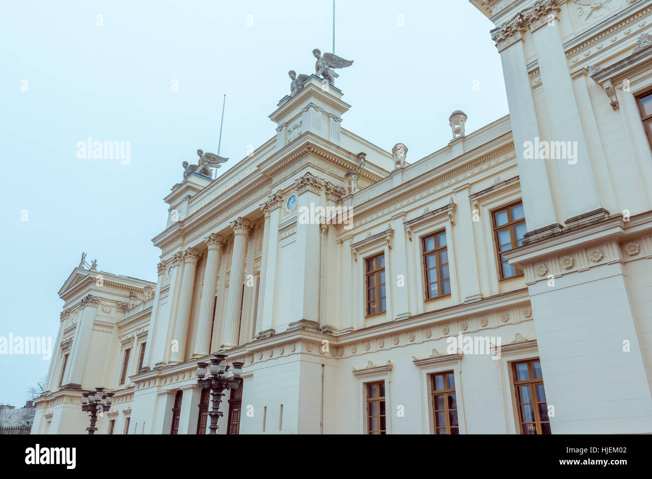Lund University main building. The facade with pillars against blue sky ...