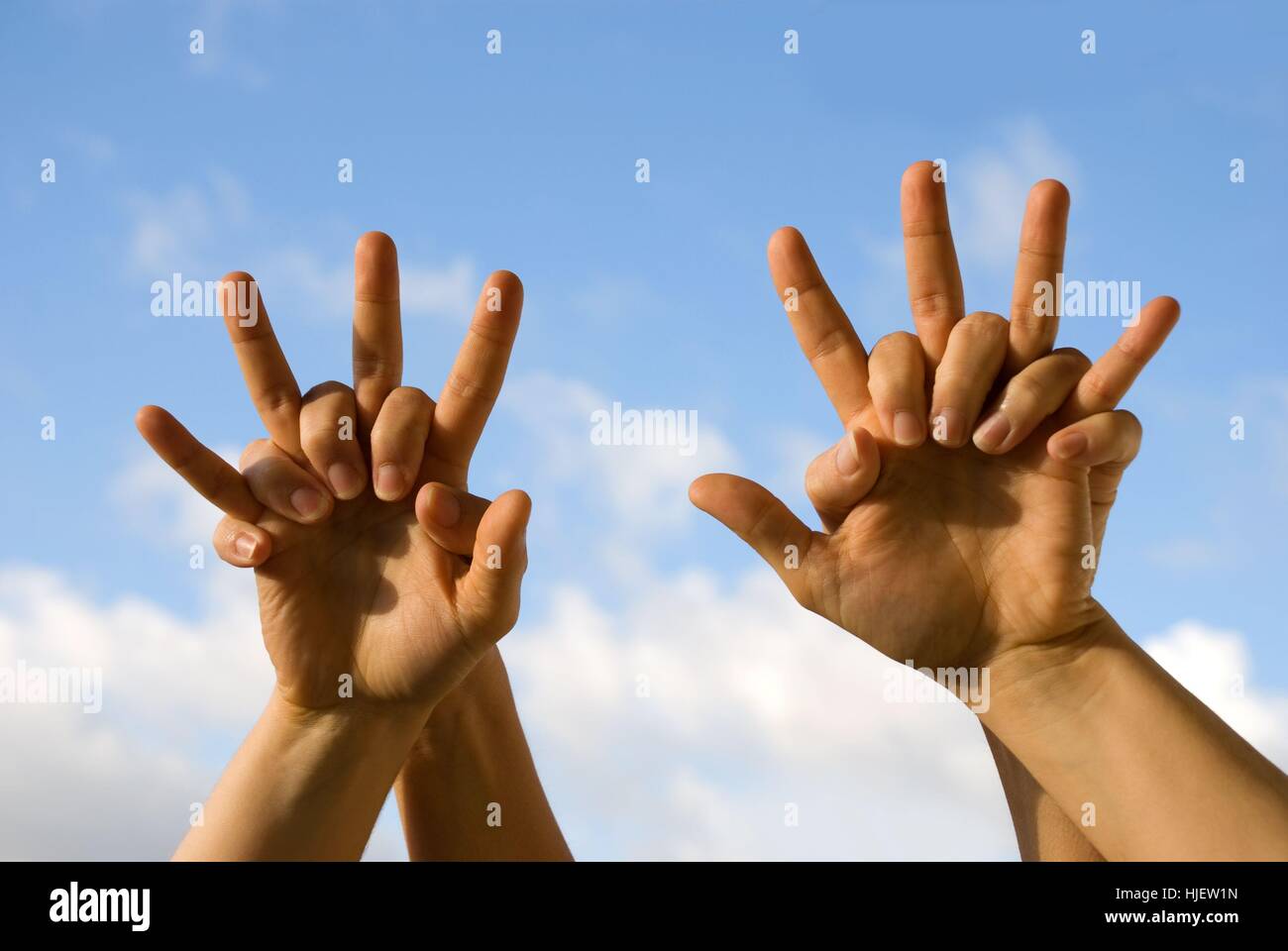four hands cheering in front of the sky Stock Photo - Alamy