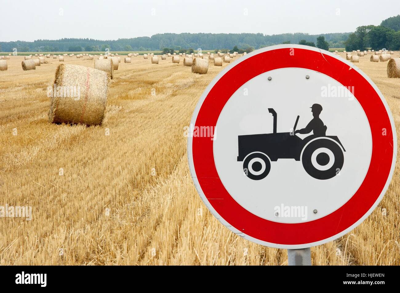 Tractor traffic sign in front of an agricultural field Stock Photo - Alamy