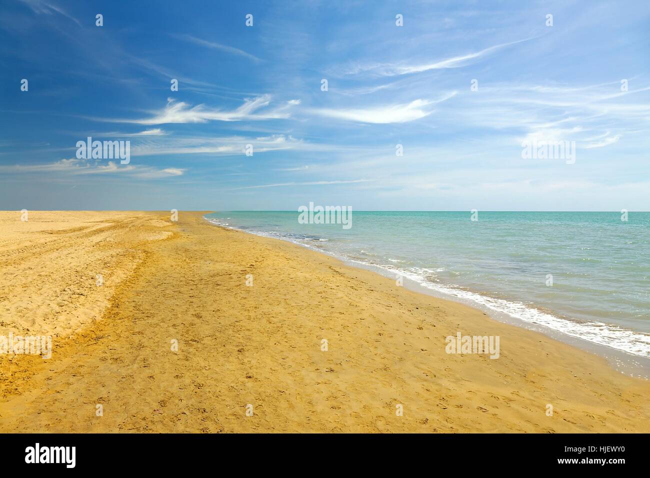 Sandy beach with blue sky Stock Photo - Alamy