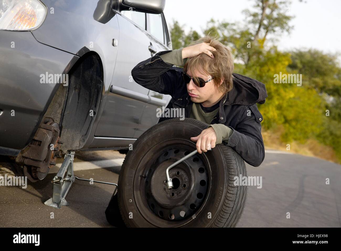 Man changing wheel on a car Stock Photo - Alamy