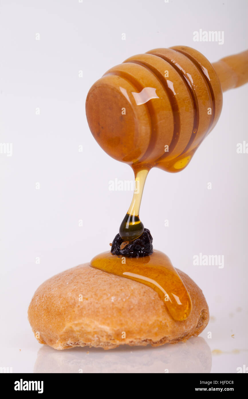 Cookie topped with honey on a light background Stock Photo - Alamy