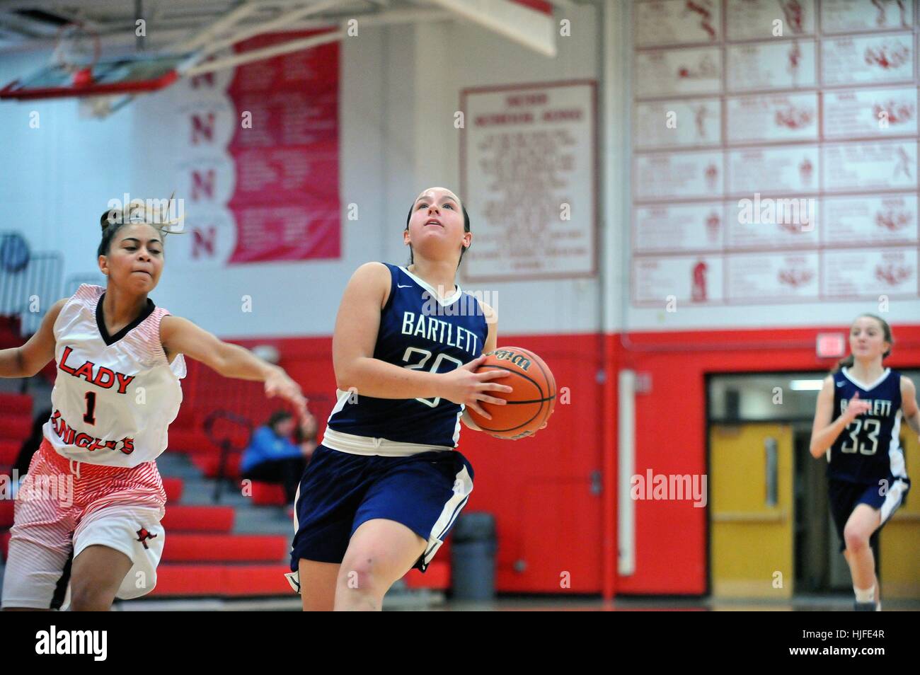 Player completing a drive to the hoop with a layup attempt during a ...