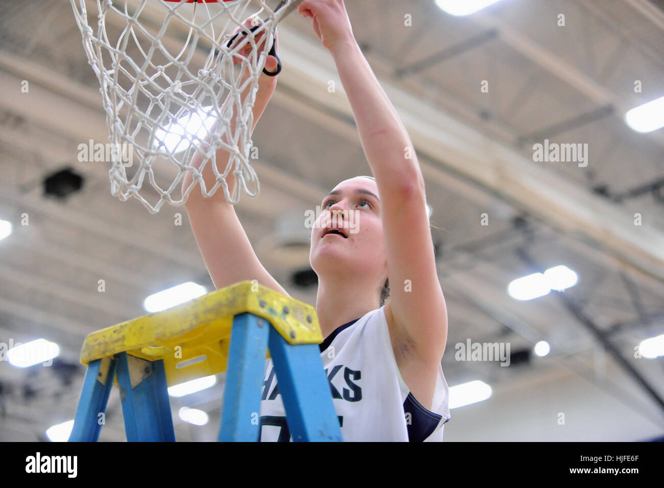 Player cutting down a segment of the net in a traditional way of ...
