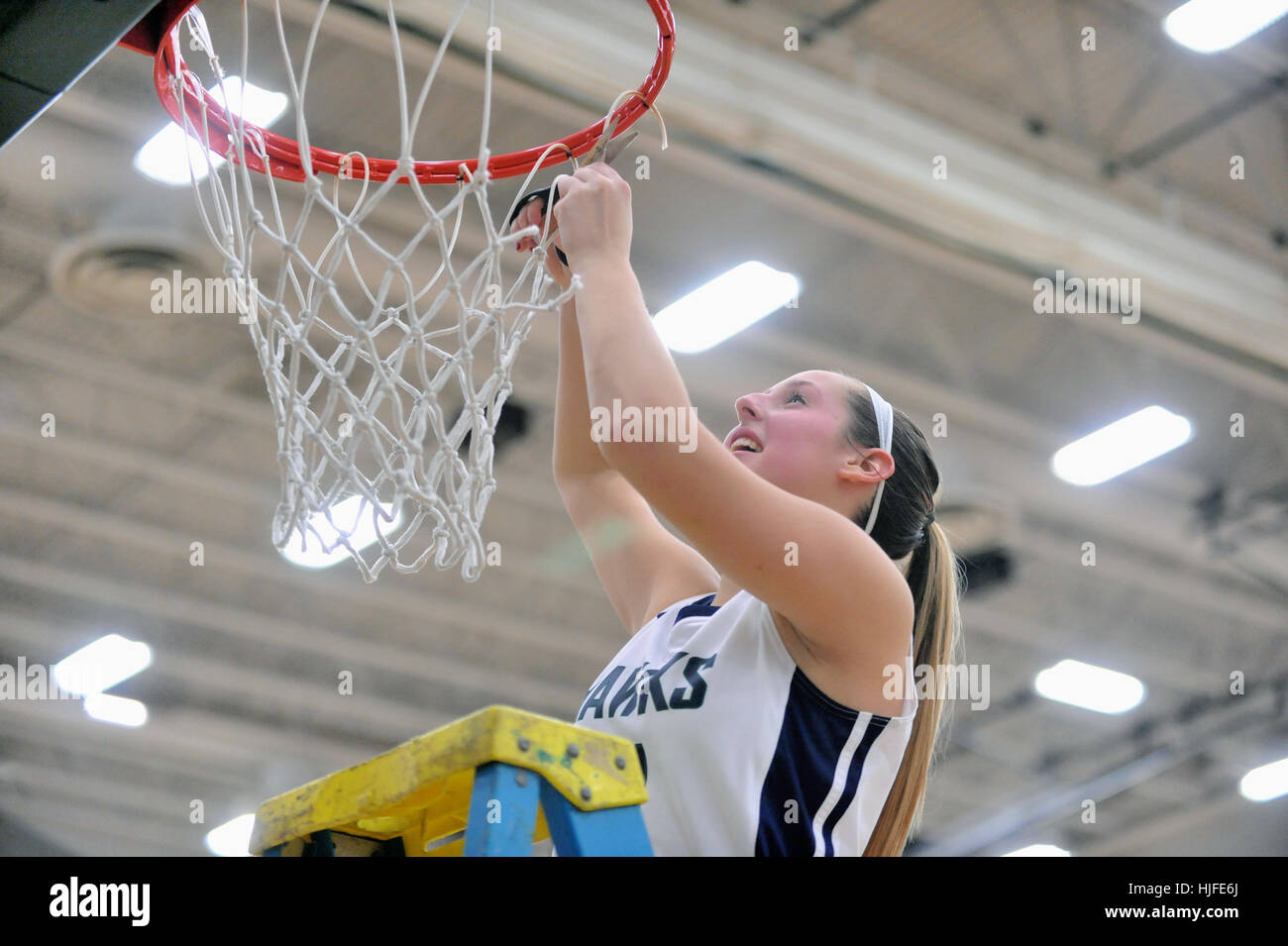 Player cutting down a segment of the net in a traditional way of ...