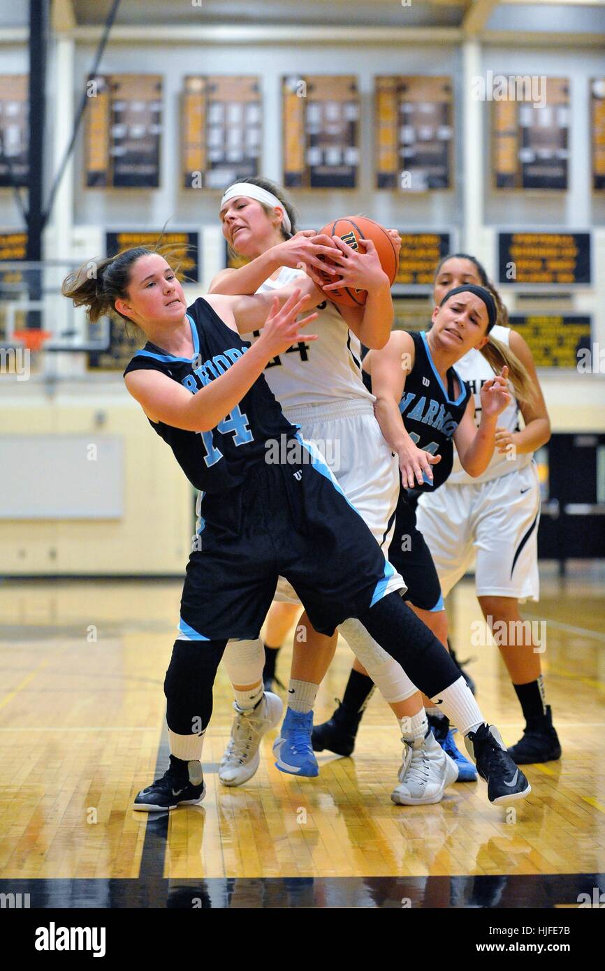 High school forward gaining an upper hand in a battle for a rebound ...