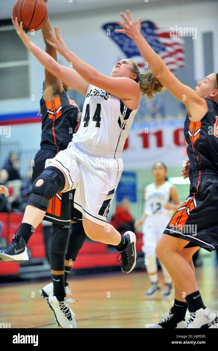 Player completing a drive to the hoop as she put up a short layup ...