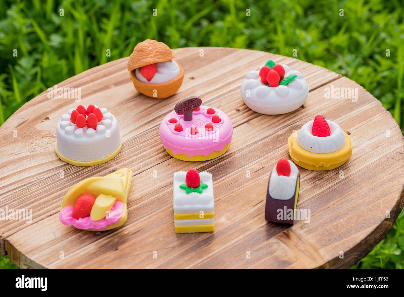 Cute cake eraser party put in a wooden table in the grass field Stock ...