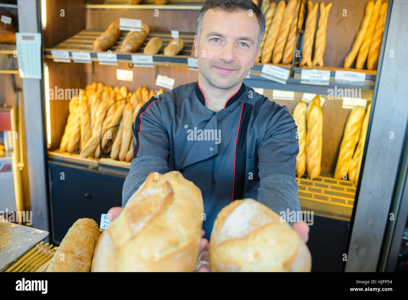 bakery shopkeeper is proud of his bread production Stock Photo - Alamy