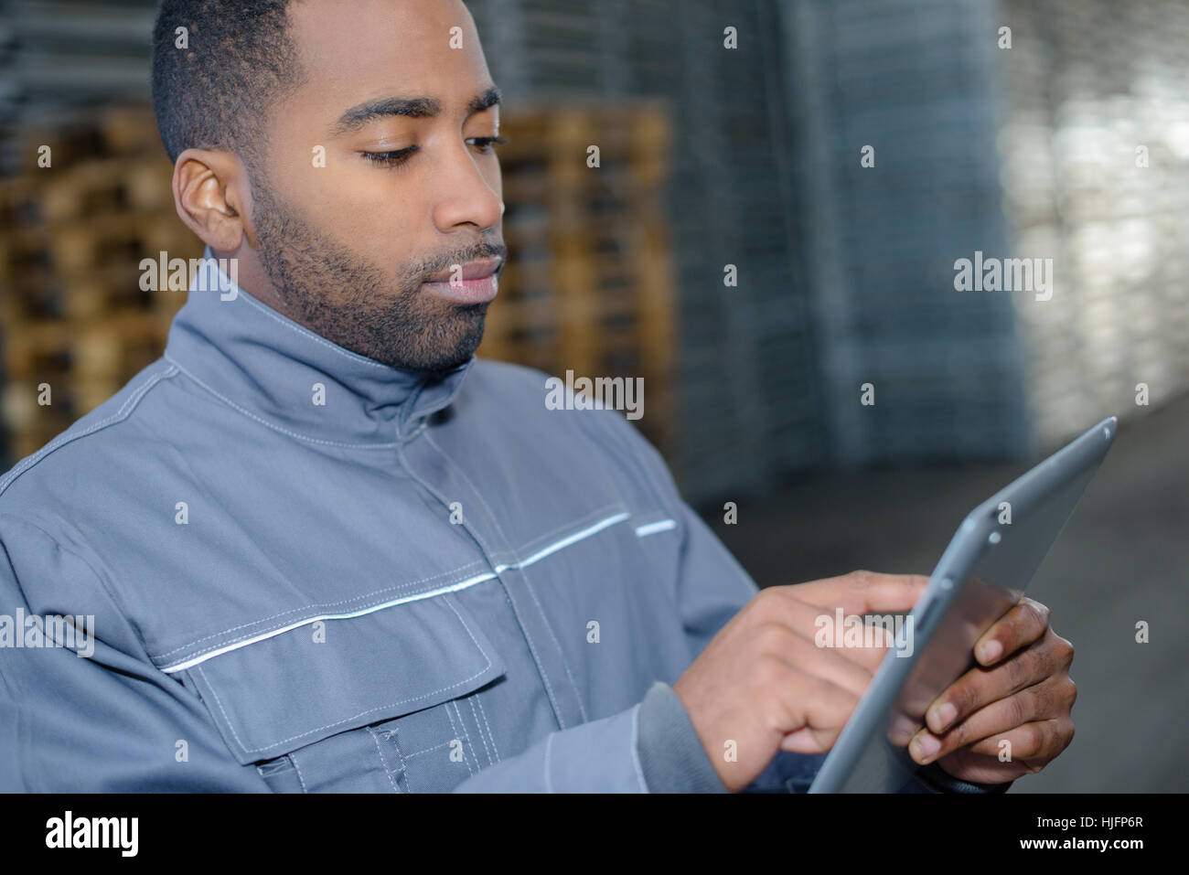 Man with tab at work hi-res stock photography and images - Alamy