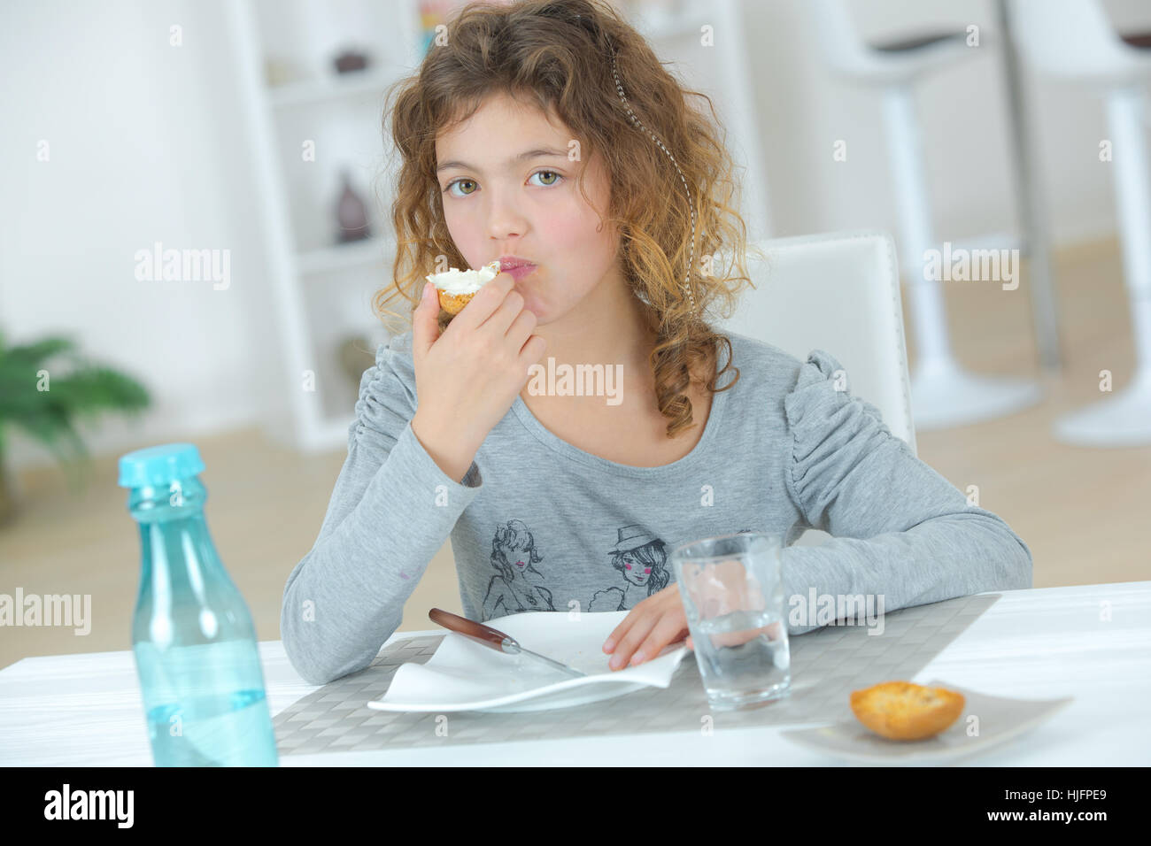 Little girl eating a snack Stock Photo - Alamy