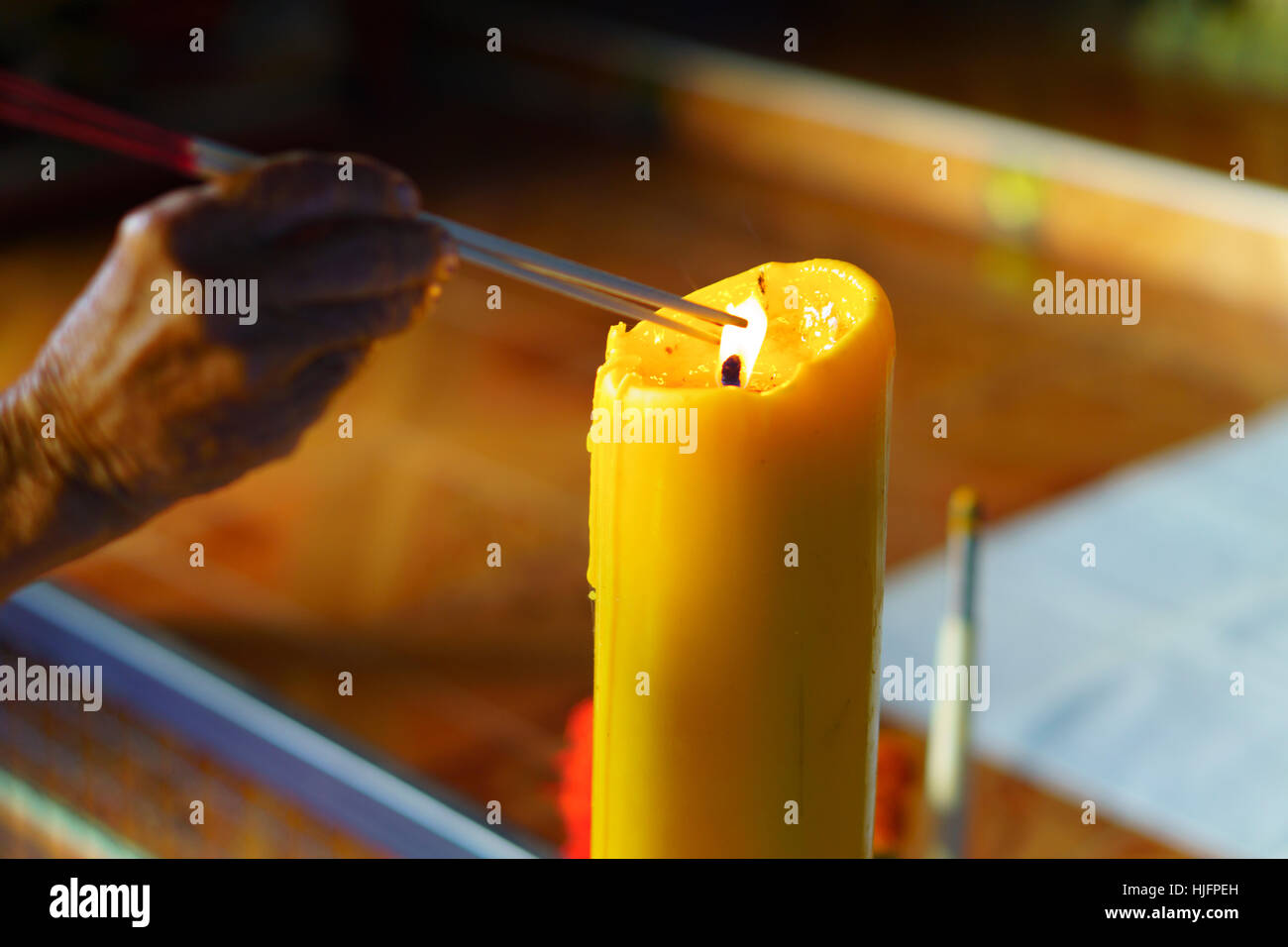 Old people is lighting incense stick Stock Photo - Alamy