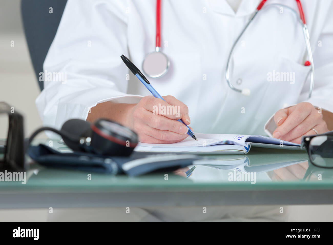 physician writing prescription-cropped image Stock Photo - Alamy