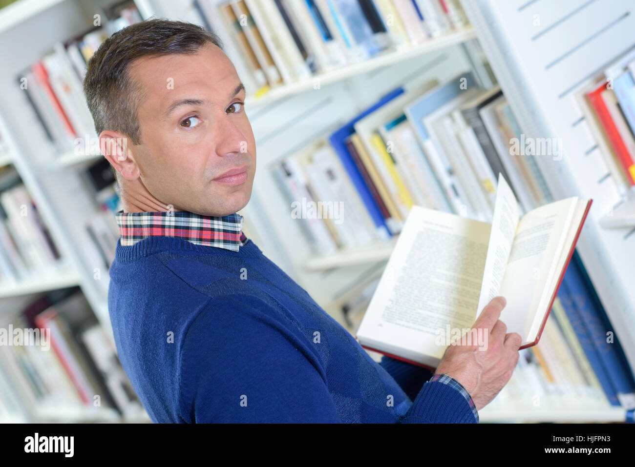man holding a book Stock Photo - Alamy