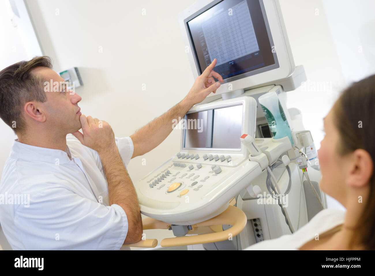 Doctor looking at ultrasound screen Stock Photo - Alamy