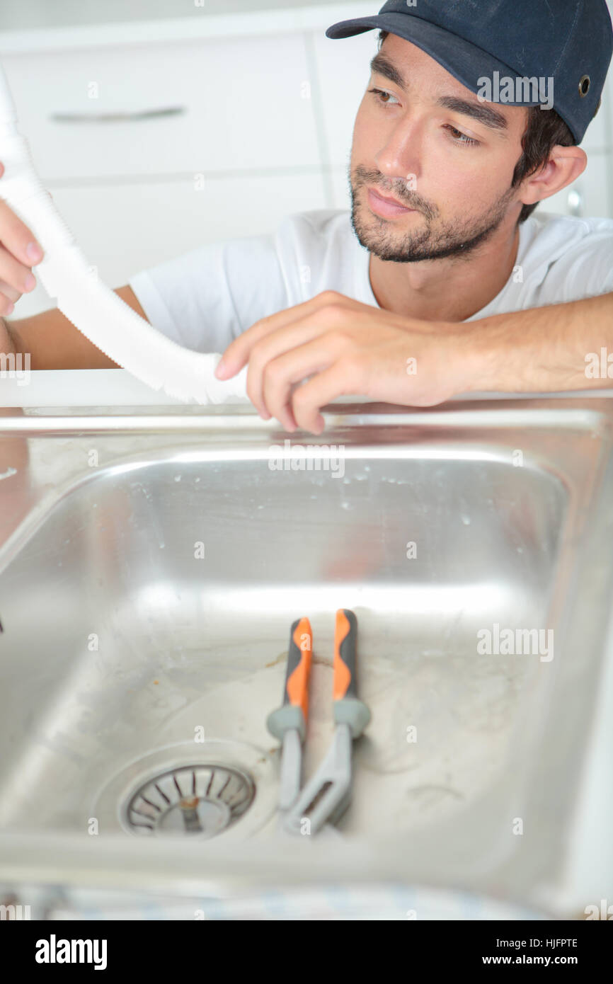 plumber in the kitchen Stock Photo - Alamy