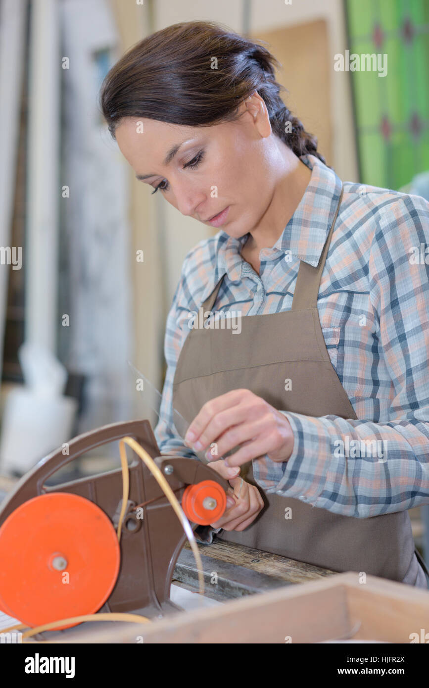 Woman using glass cutter Stock Photo - Alamy